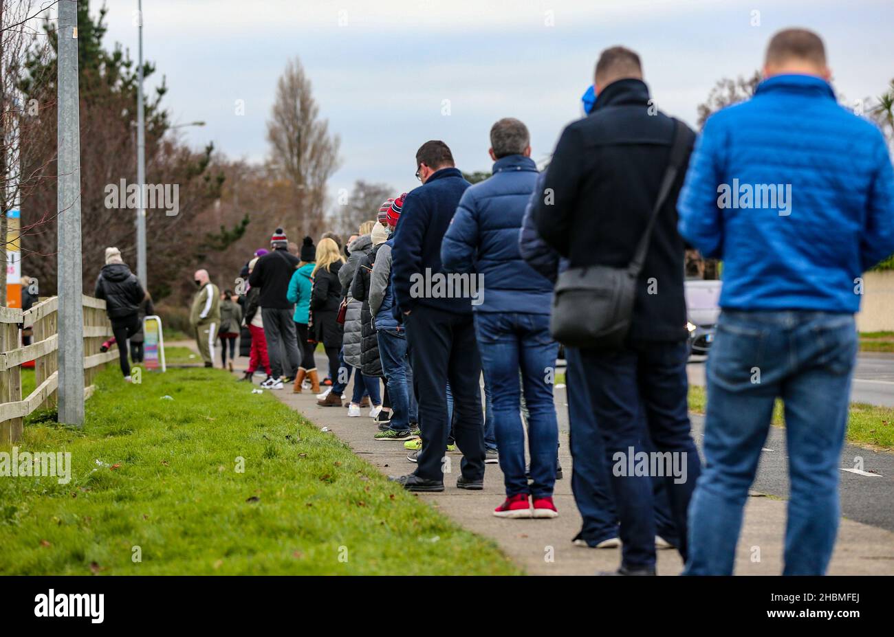 People queue outside a covid-19 booster walk-in clinic at a centre in ...
