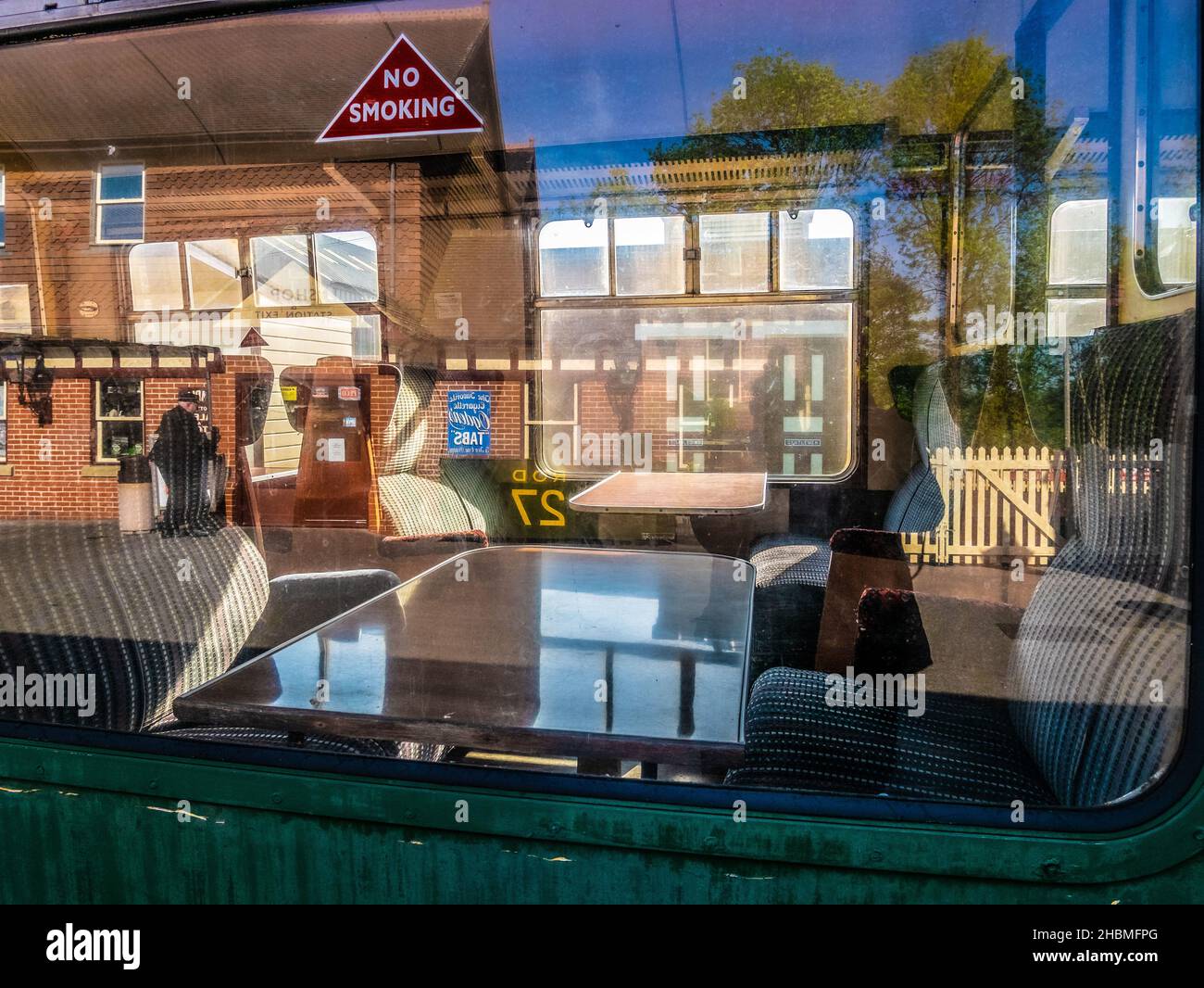 Looking in through a window of a passenger car of a vintage steam train ...