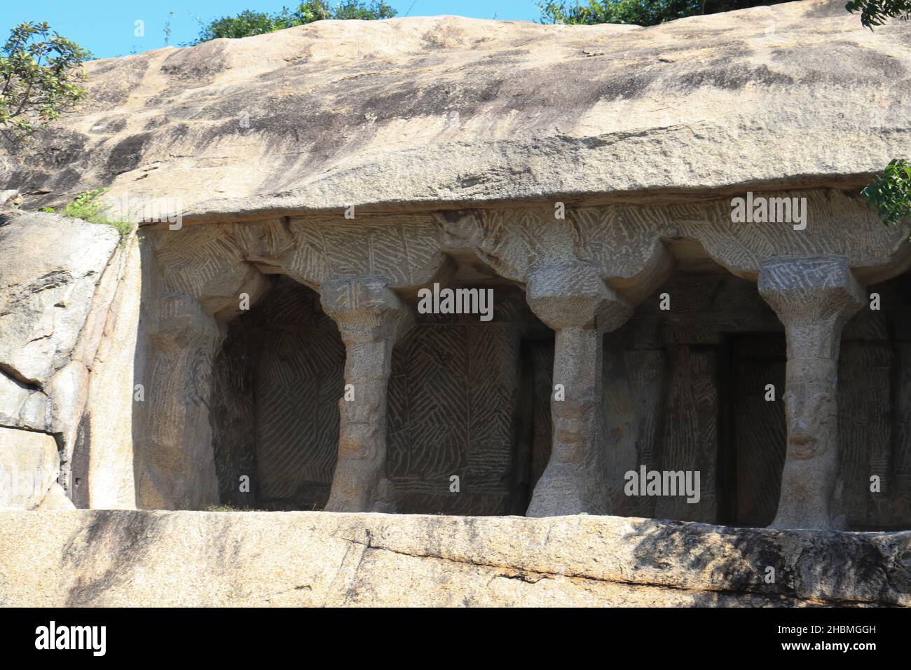 The cave temple carved in the rock and its pillars. It is incomplete ...