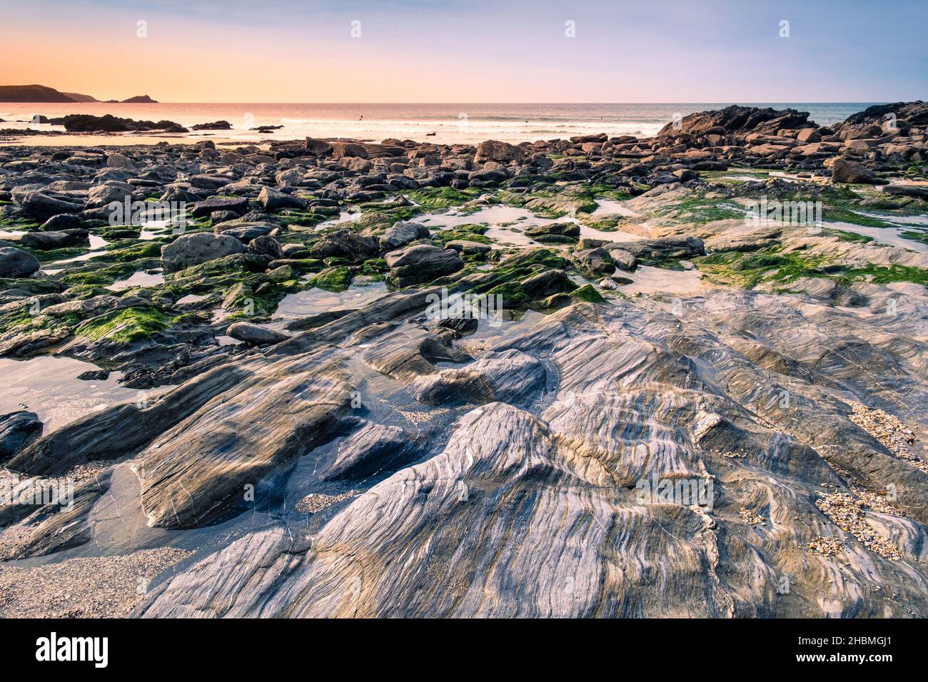 Rocks and rock pools at low tide at the secluded Little Fistral in ...