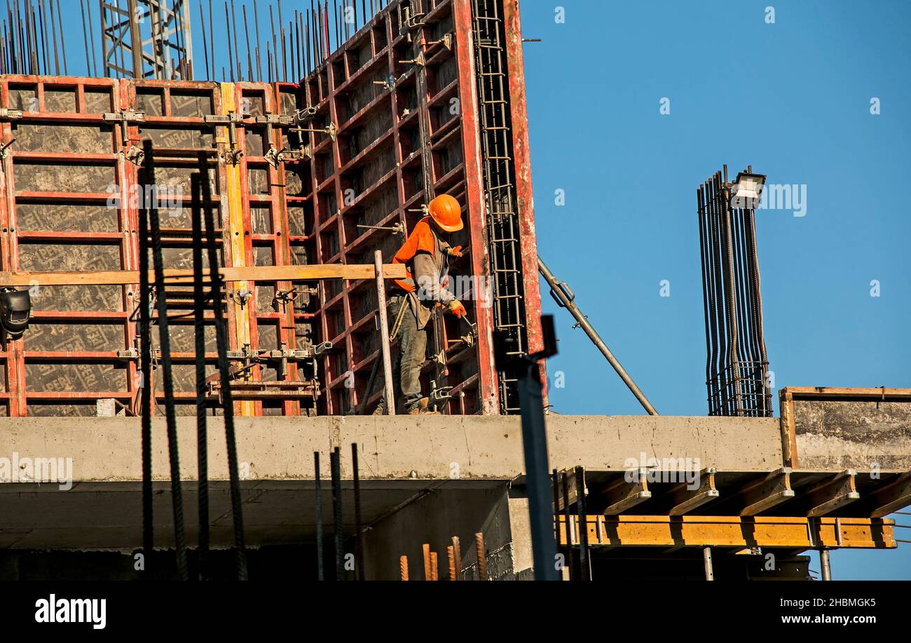 Construction of a high-rise building. Workers prepare formwork for ...