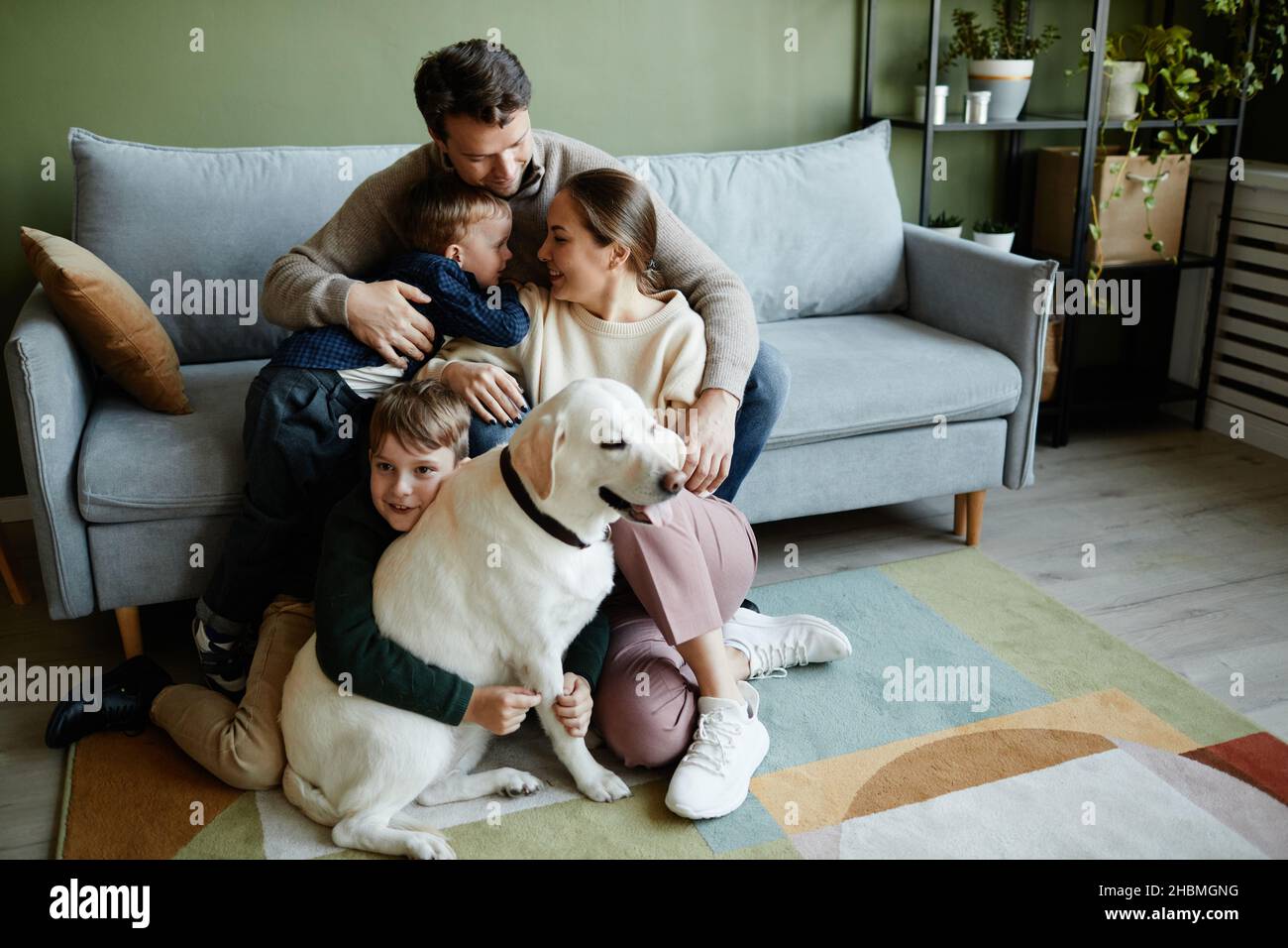 Full length portrait of big happy family with two kids and dog all ...