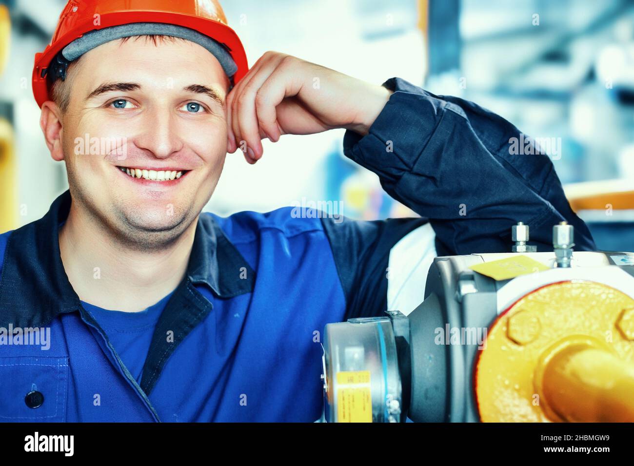 This is portrait of worker in helmet and clothes. Smiling engineer of ...