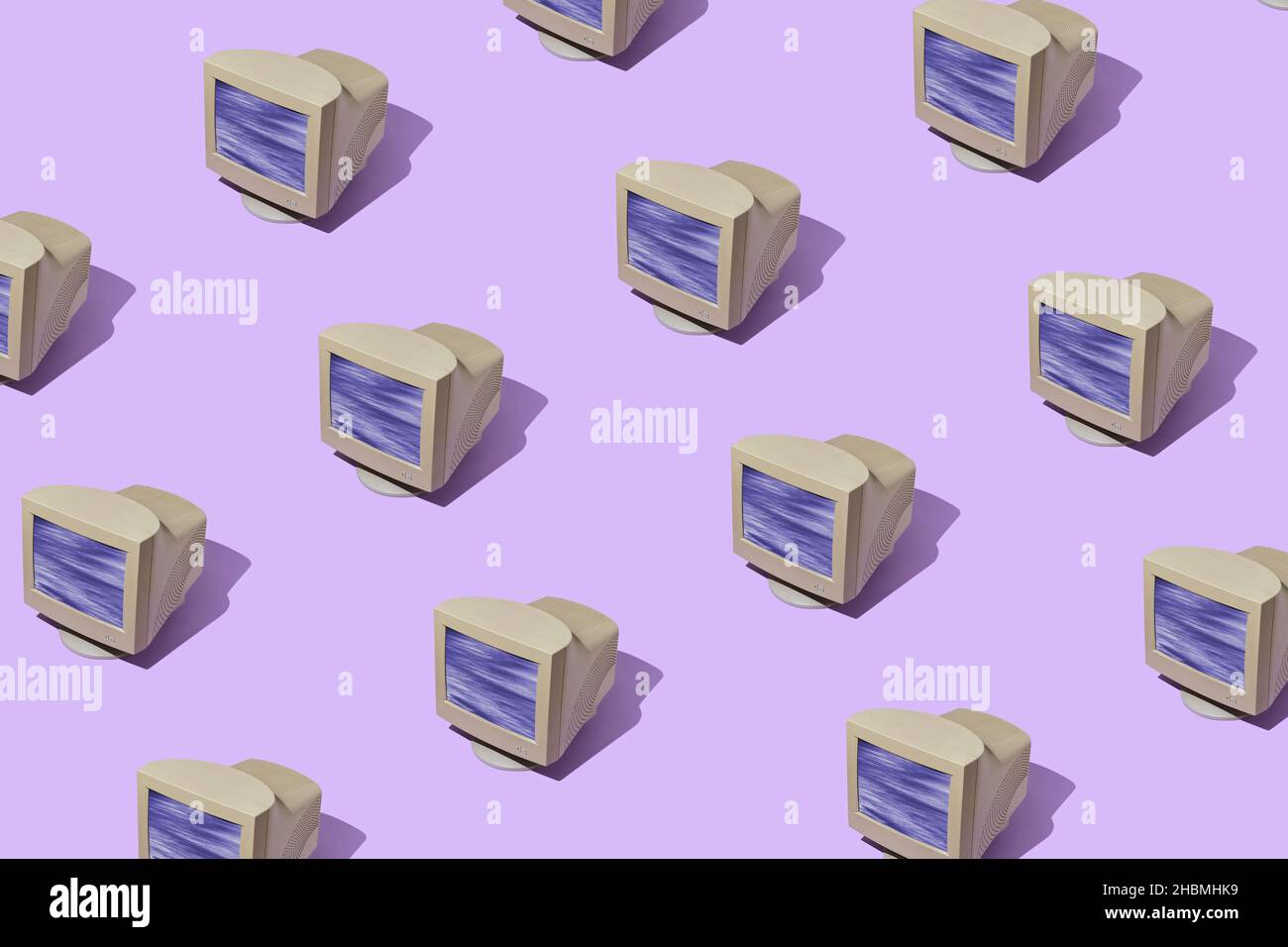 Pattern of vintage computer monitors in diagonal rows over a colorful ...
