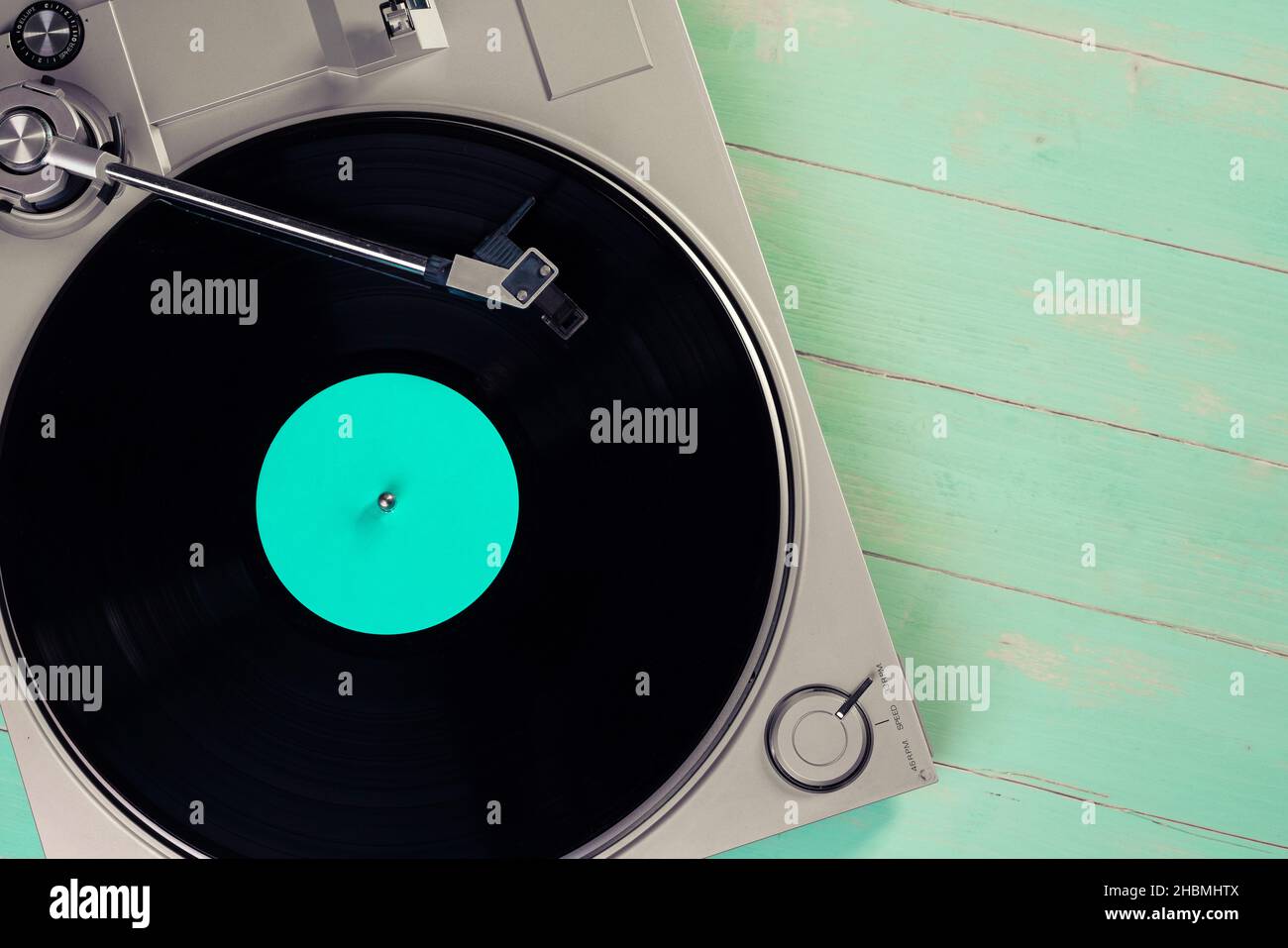 Gramophone with a vinyl record on wooden table, top view and copy space ...