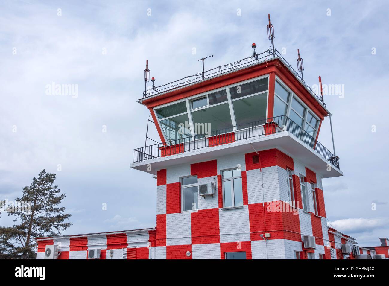 Red and white in the square of the control tower at the airport runway ...