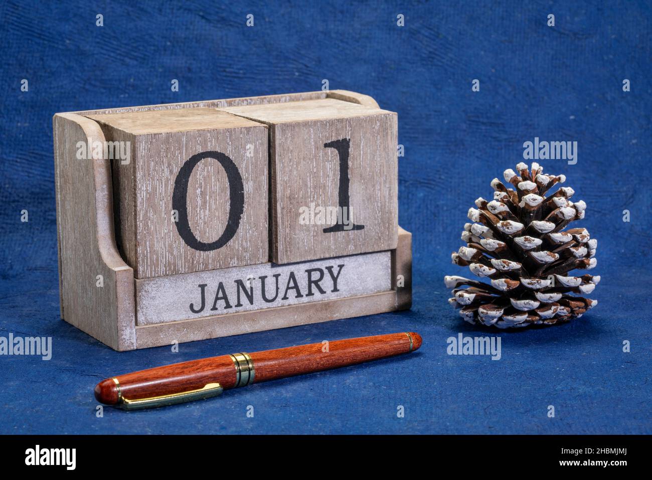 January 1 date in a rustic wood block calendar with a decorative frosty ...