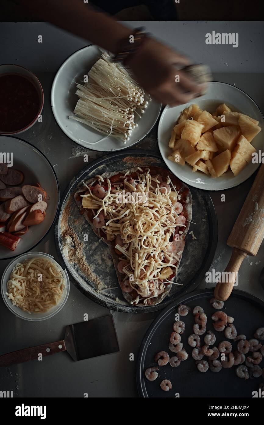 A closeup of hand making an Italian pizza on a floured surface Stock ...