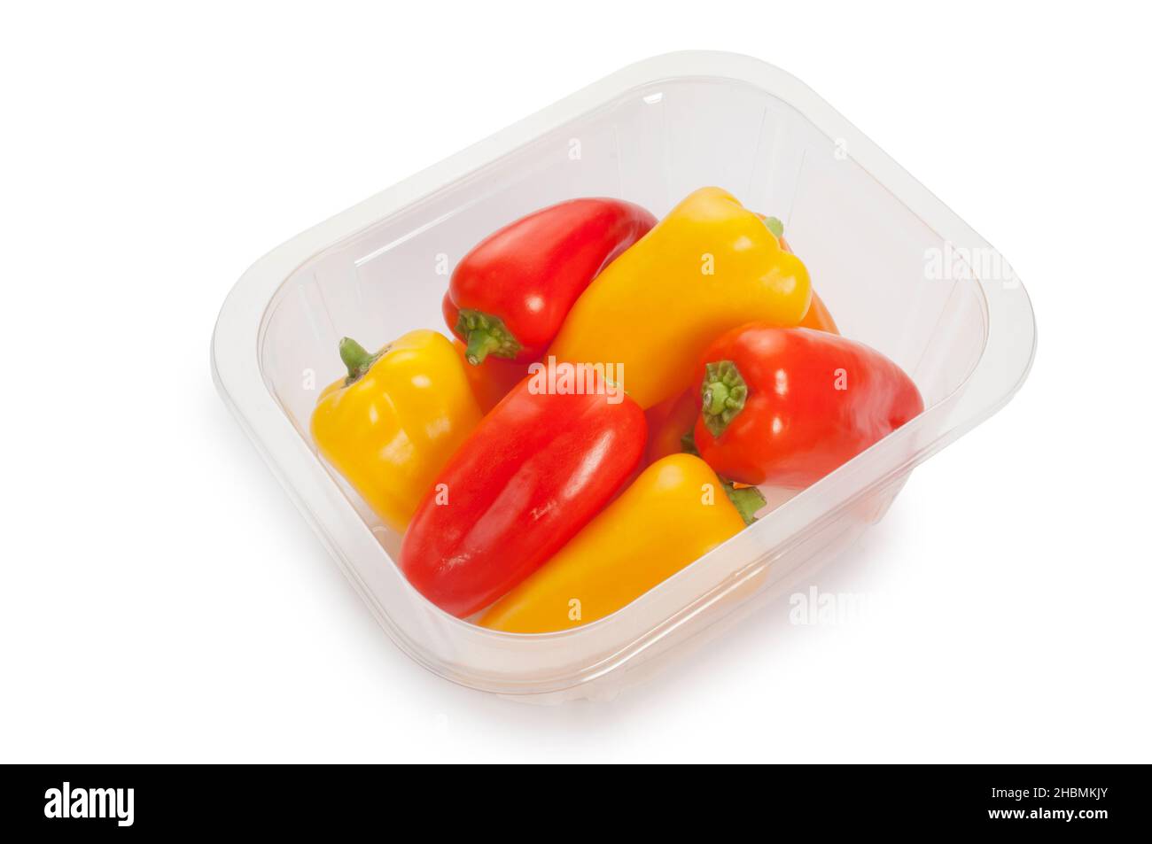 Studio shot of small chili peppers in plastic packaging cut out against ...