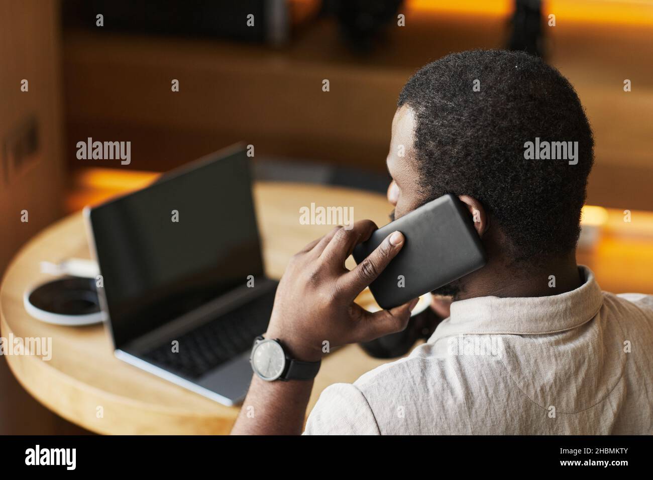 Back view of black man sitting at table hi-res stock photography and ...
