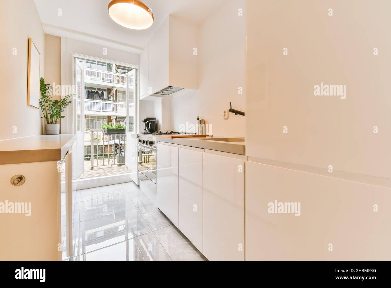 Modern minimalist kitchen with glossy kitchen set Stock Photo - Alamy