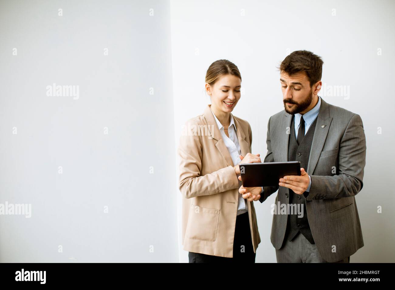 Young people with digital tablet by the wall in the modern office Stock ...