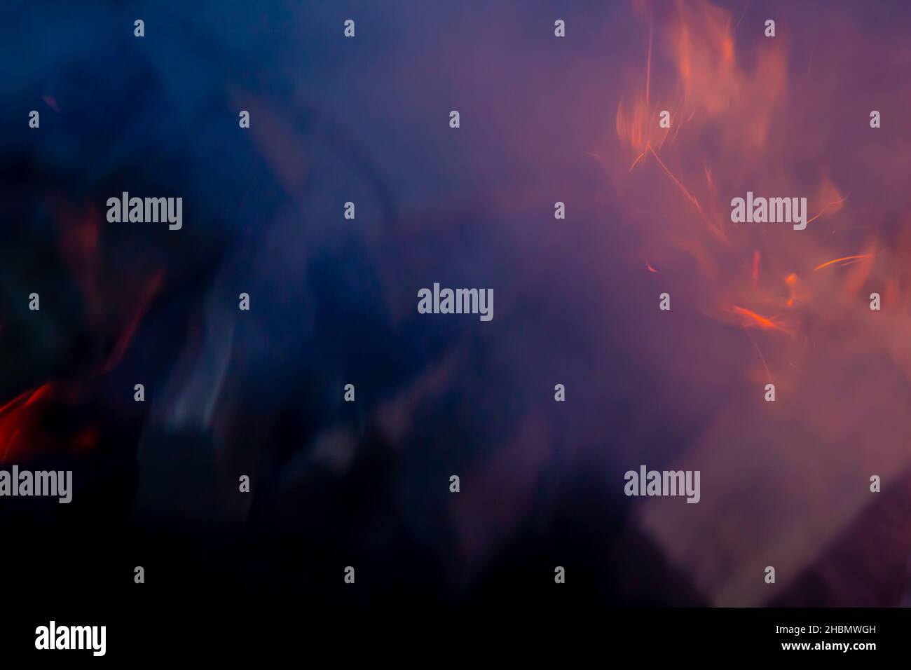 gray smoke background, fire in the grill at night close-up, fire flame ...