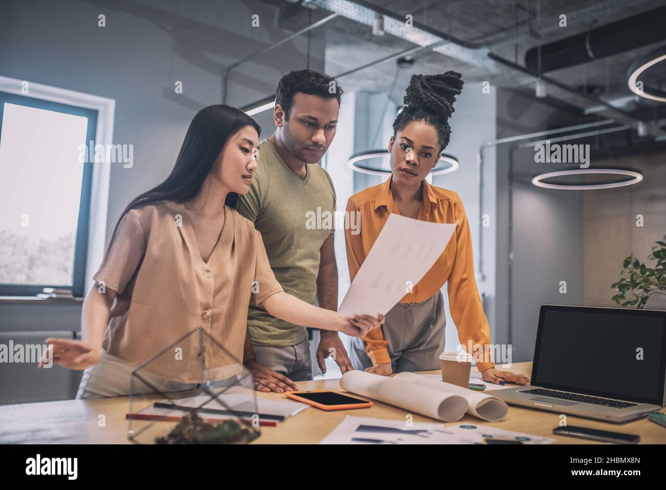Two colleagues looking at paper hi-res stock photography and images - Alamy