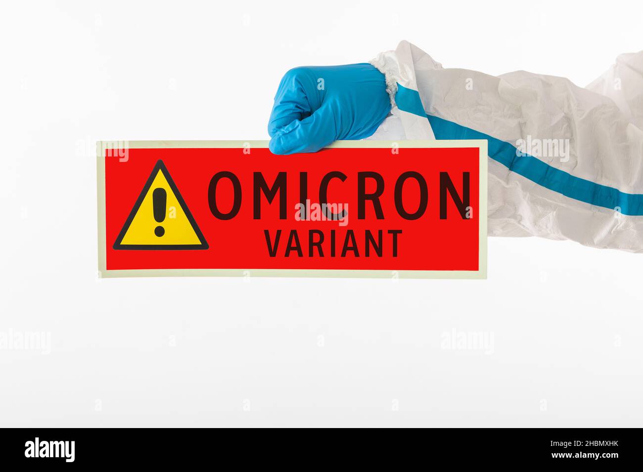 Detail of the arms of a medical nurse wearing a PPE and latex gloves ...