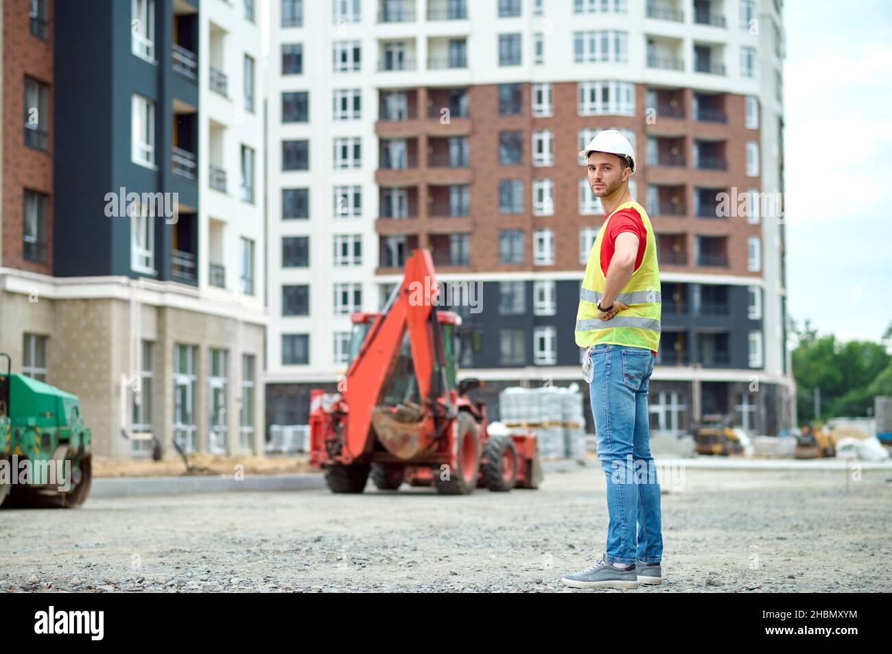 Man in protective helmet turning head towards camera Stock Photo - Alamy