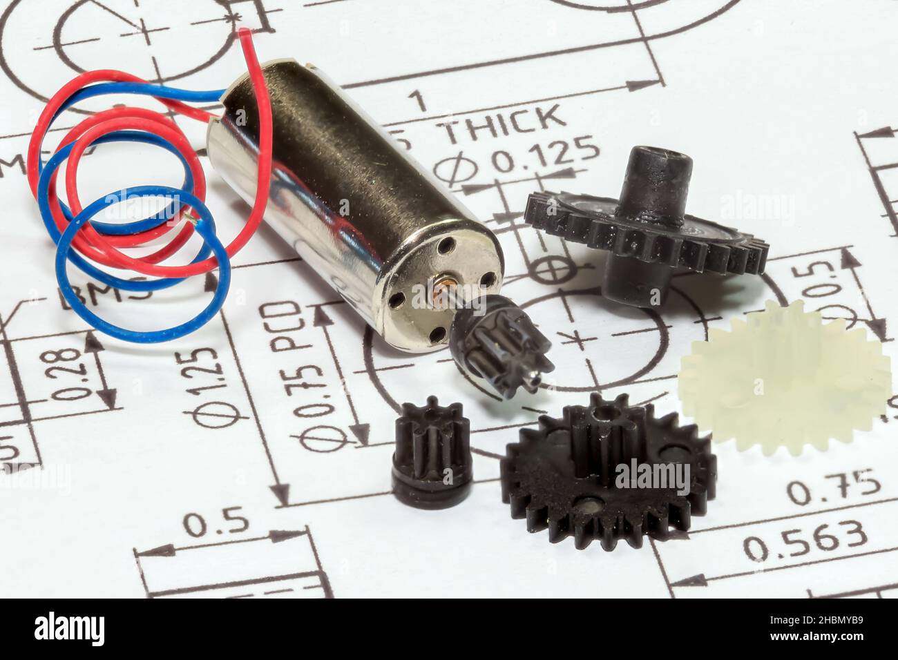 Closeup on a miniature electric motor with nylon gears placed on a ...