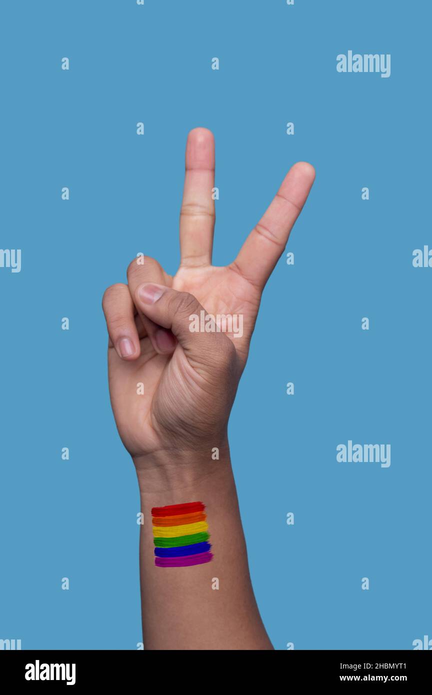 Person making a victory gesture with two raised fingers Stock Photo - Alamy