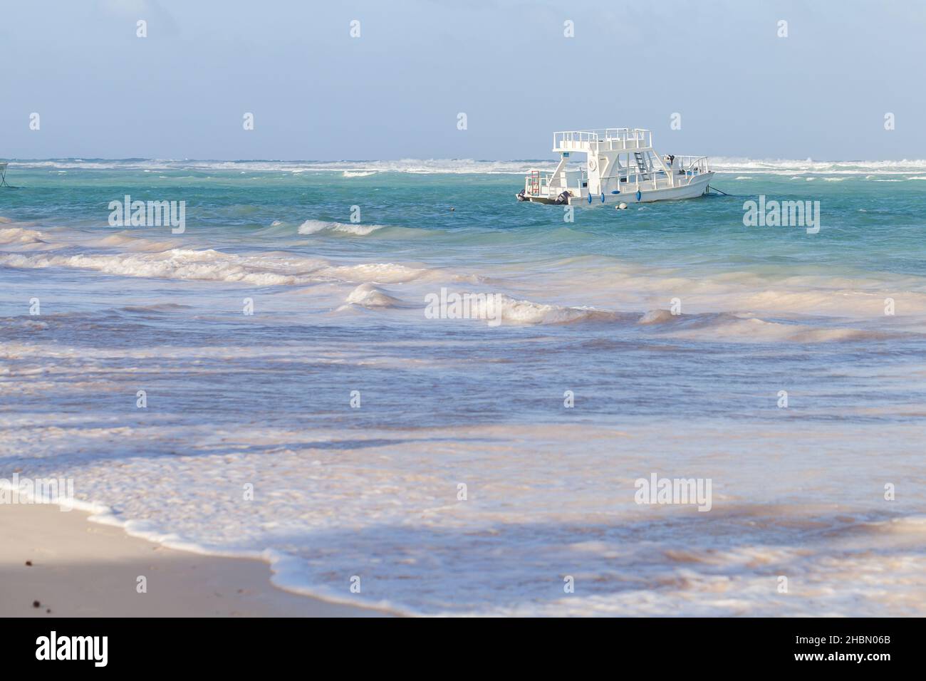 Coastal Caribbean landscape with white pleasure catamaran boat ...