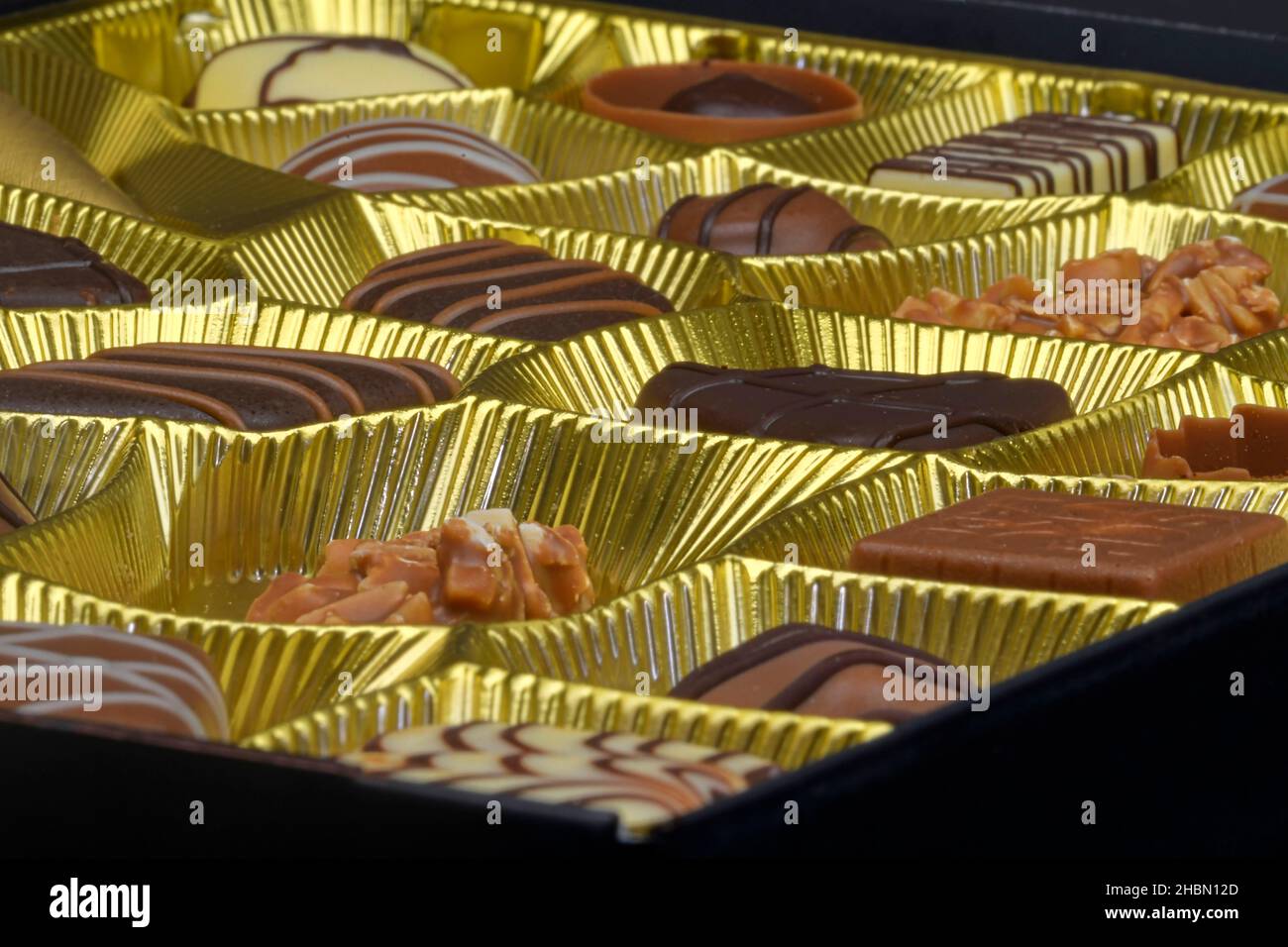 Different chocolate pralines. Box of belgian pralines of different ...