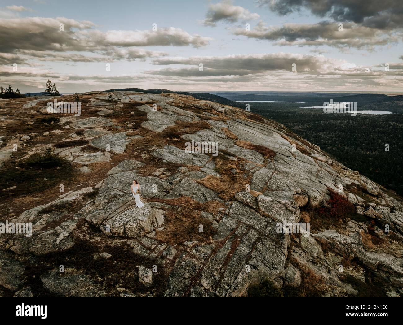 aerial of bride in white wedding dress on mountaintop, Maine Stock ...