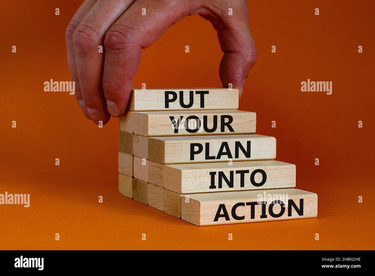 Put your plan into action symbol. Wooden blocks with words Put your ...