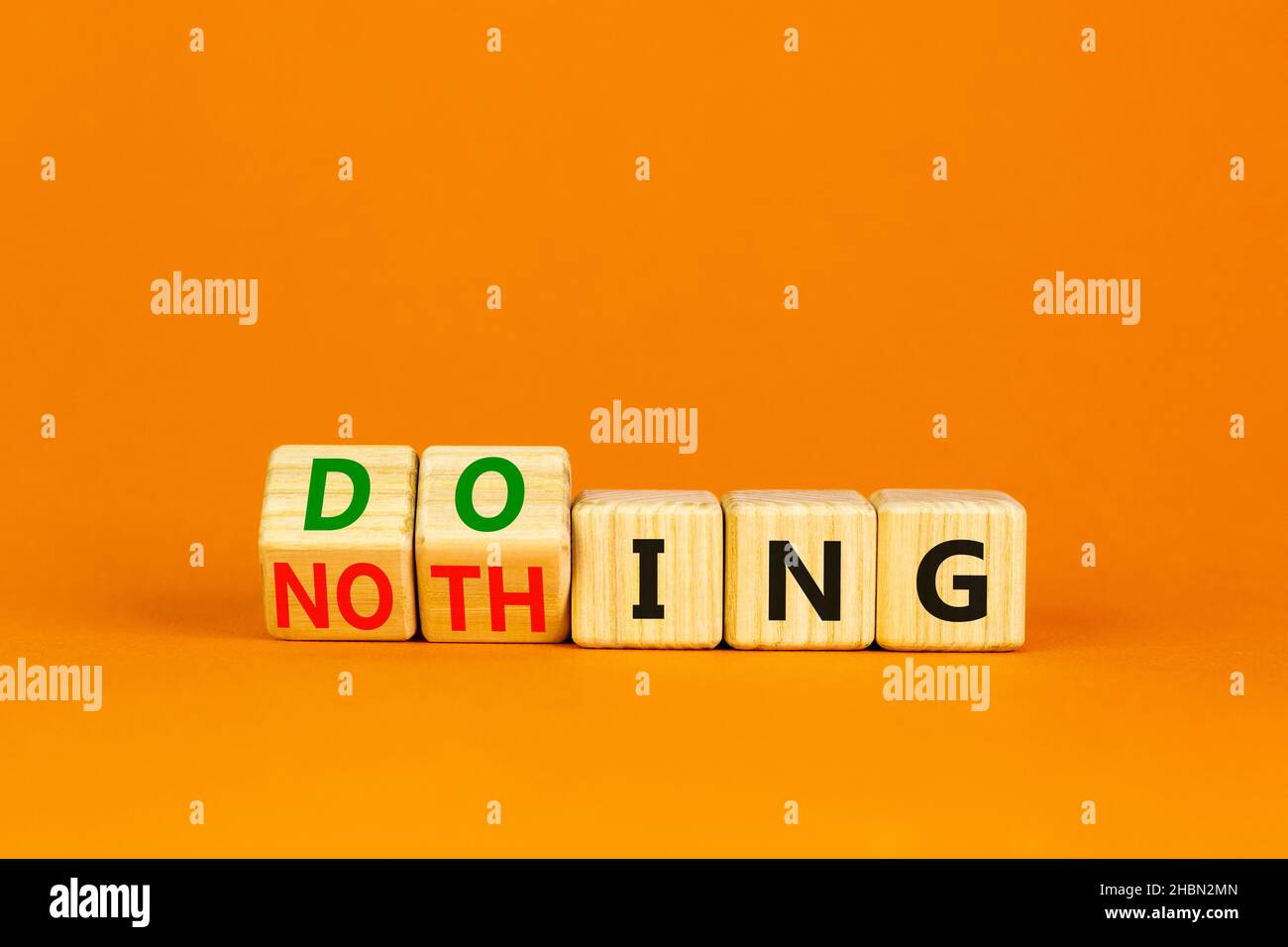 Doing or nothing symbol. Wooden cubes with changed the concept word ...