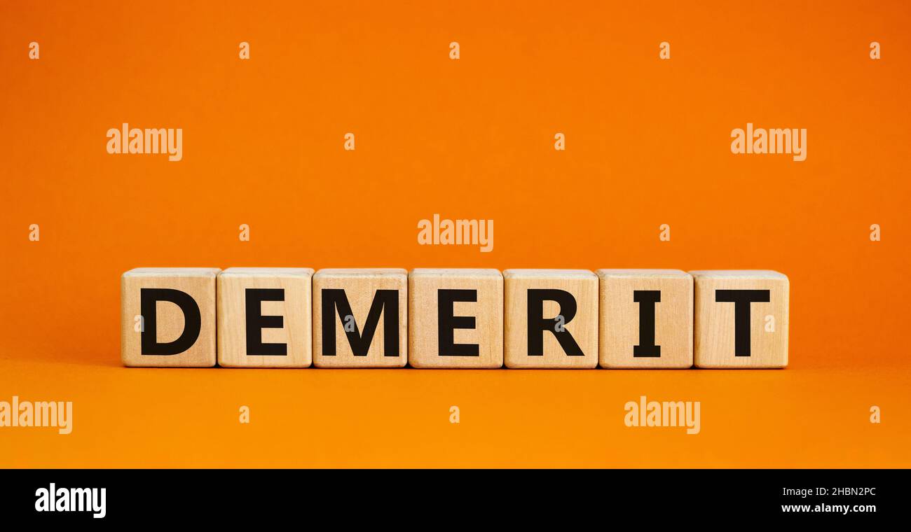 Demerit symbol. The concept word Demerit on wooden cubes. Beautiful ...