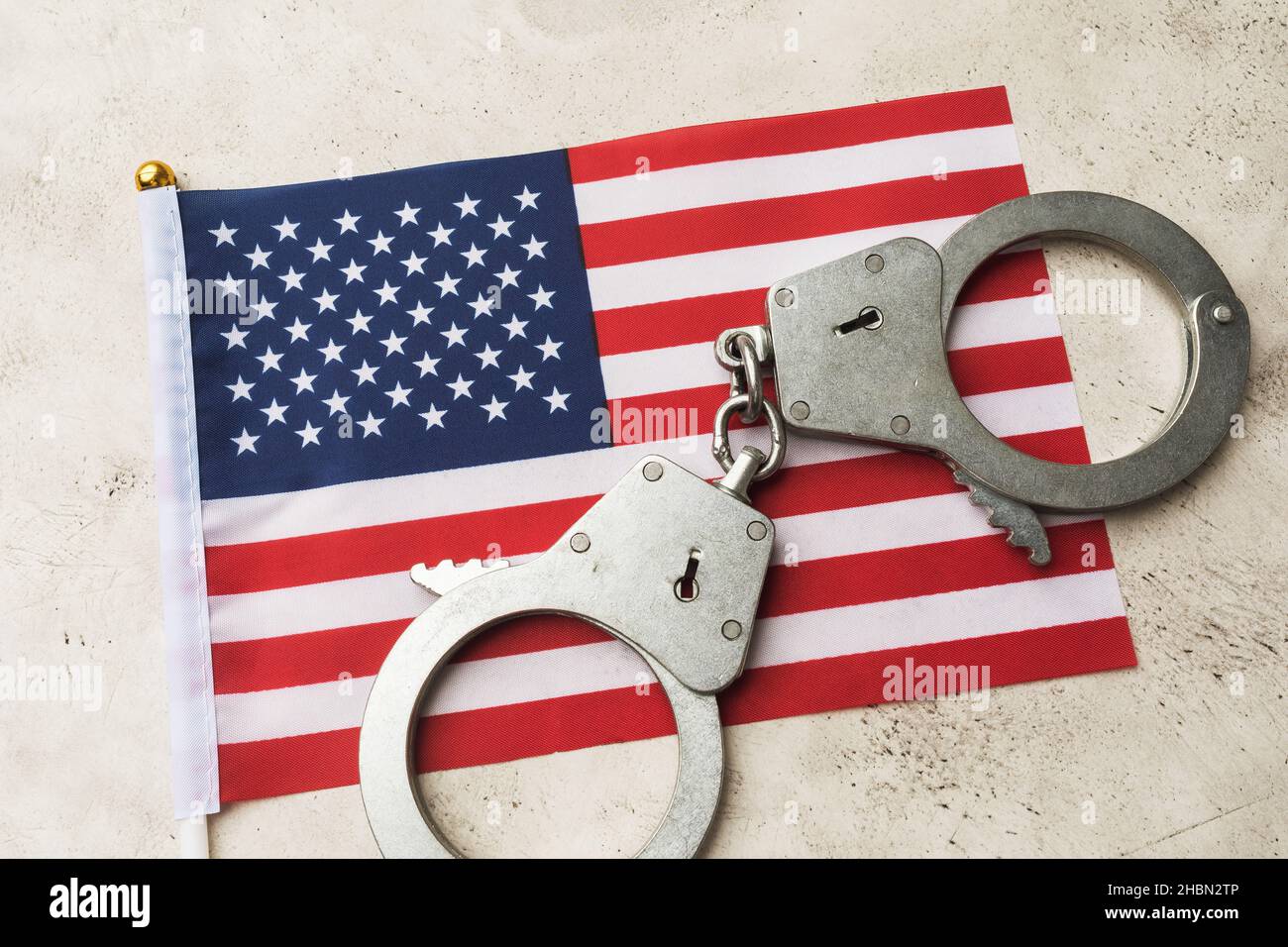 USA flag and handcuffs on an abstract background, the concept of crime ...