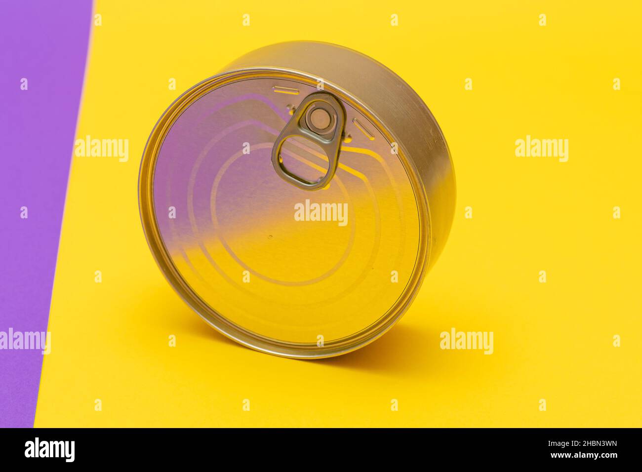 Unopened Tin Can with Blank Edge on Split Yellow and Violet Background ...