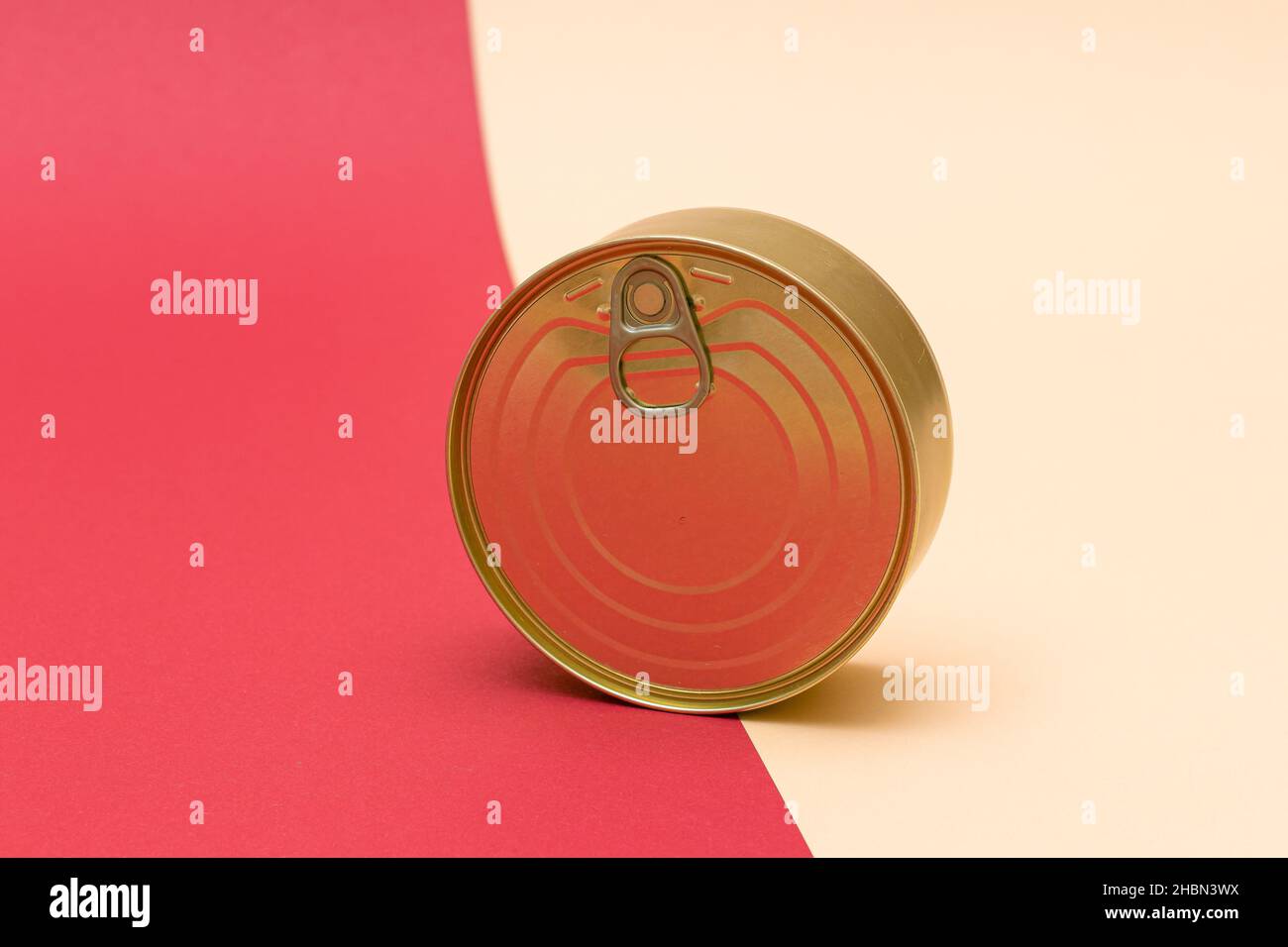 Unopened Tin Can with Blank Edge on Split Red and Beige Background ...