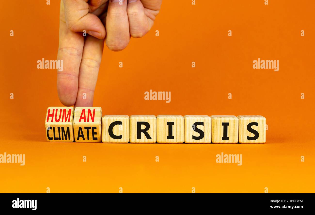 Climate or human crisis symbol. Businessman turns wooden cubes and ...