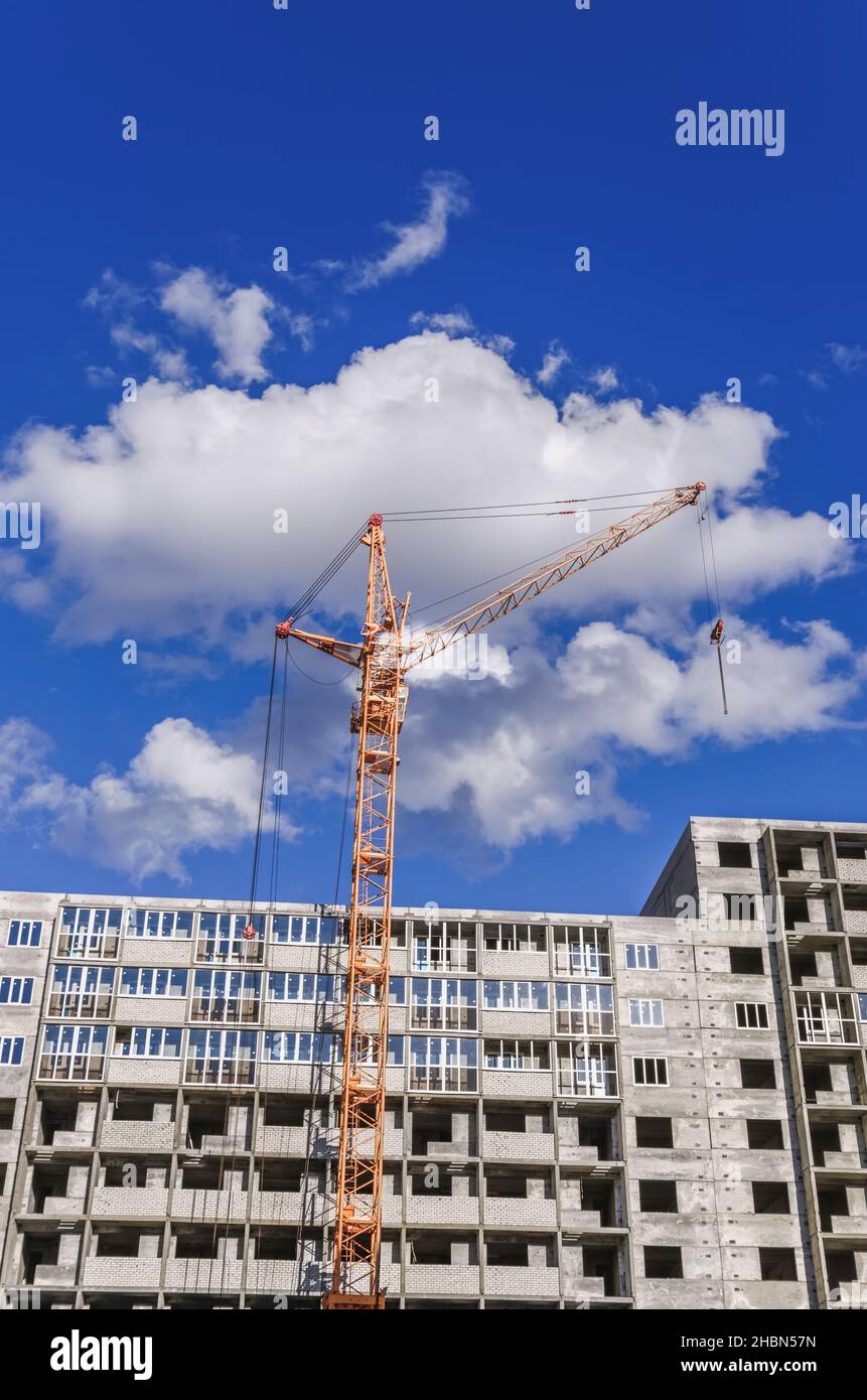 Multi-storey housing under construction and powerful crane Stock Photo ...