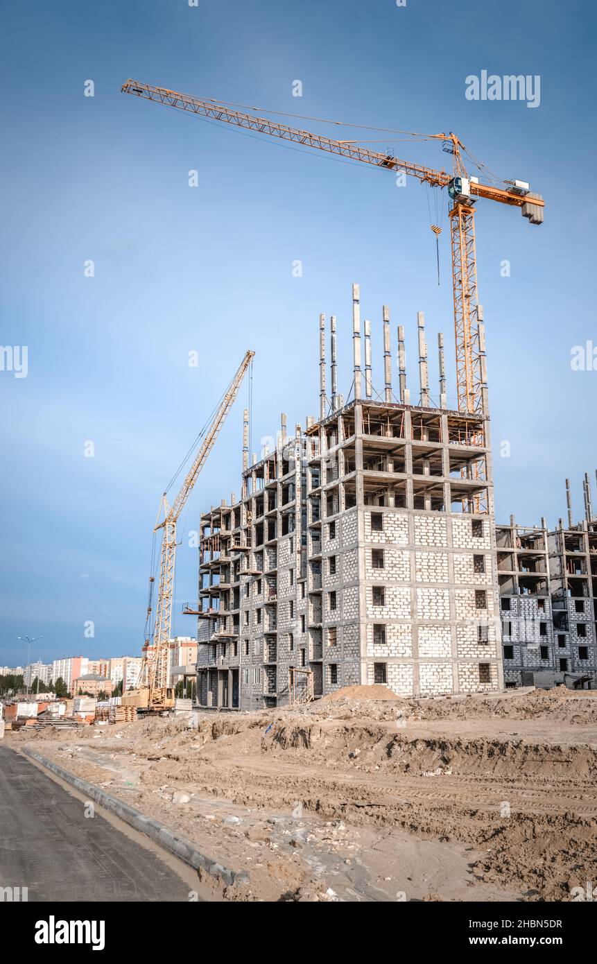 Building multi storey houses and hoisting crane hi-res stock ...