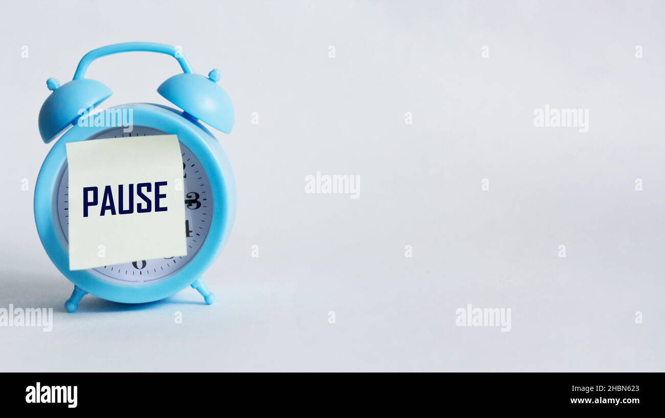 On a white background, an alarm clock with a light sticker with the ...