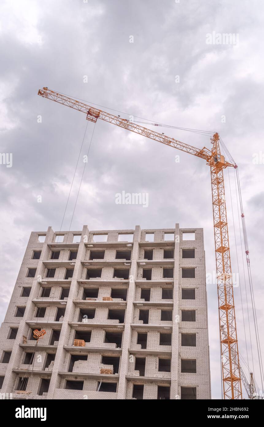 Building multistorey houses and hoisting cranes Stock Photo - Alamy