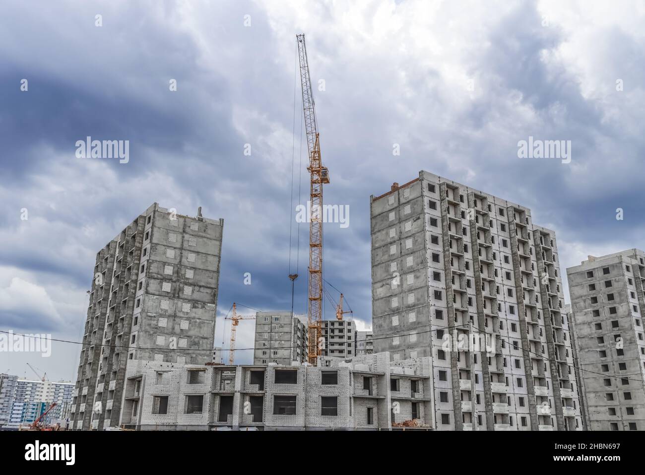 Building multi-storey houses and hoisting crane Stock Photo - Alamy