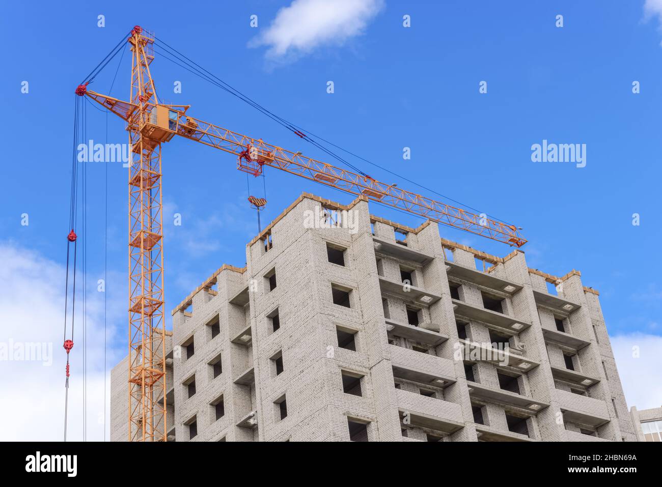 Construction of high-rise houses and hoist crane Stock Photo - Alamy