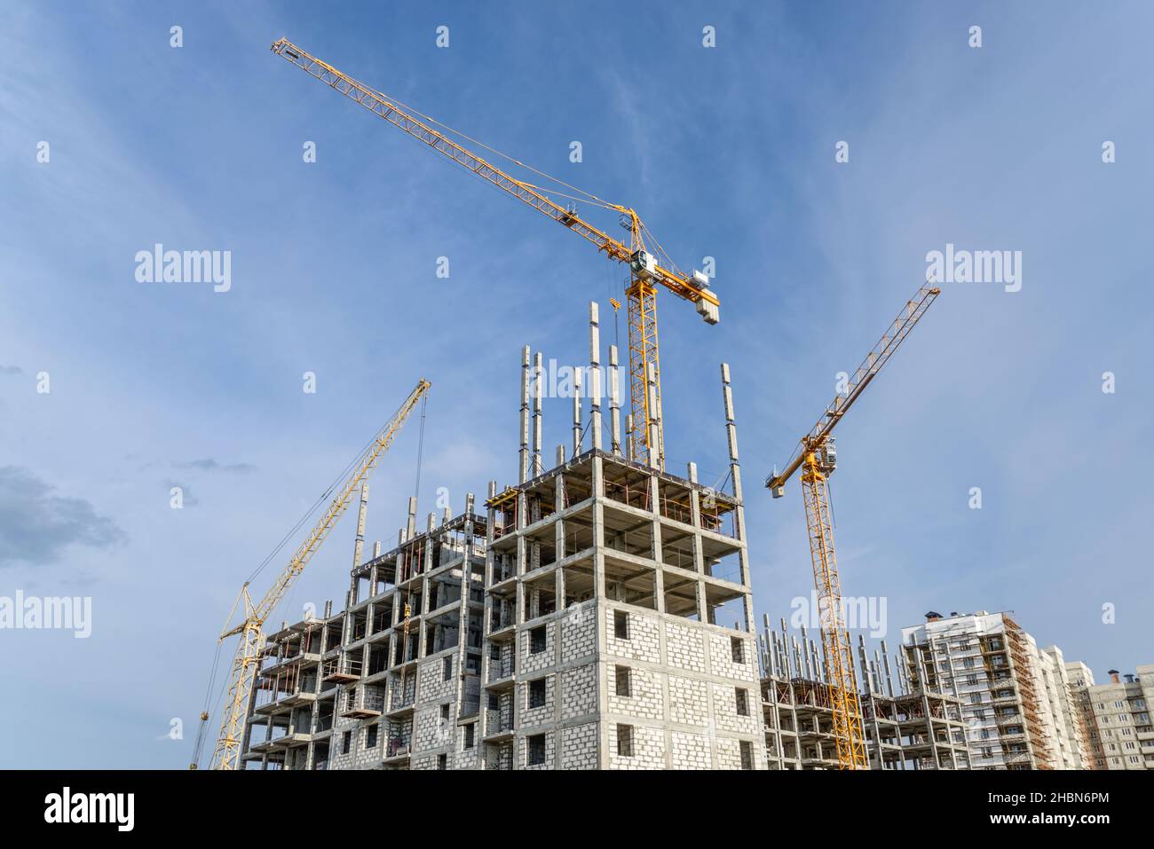 High-rise building and hoisting tower cranes Stock Photo - Alamy