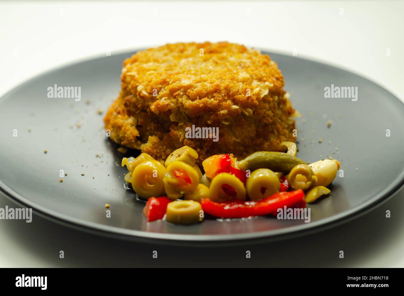 Cod and prawns red Thai style fish cake served with pickled olives ...