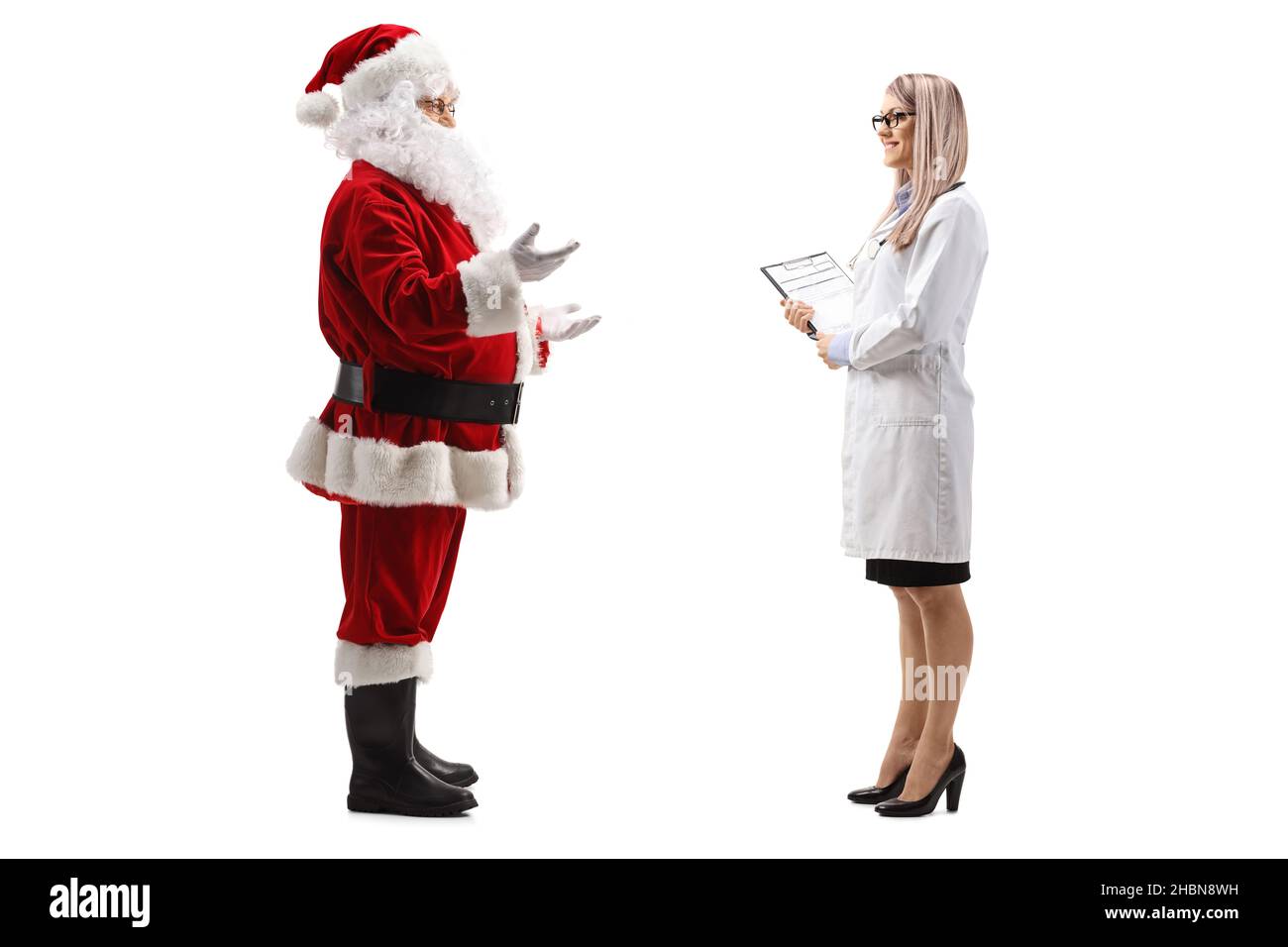 Full length profile shot of santa claus talking to a young female ...
