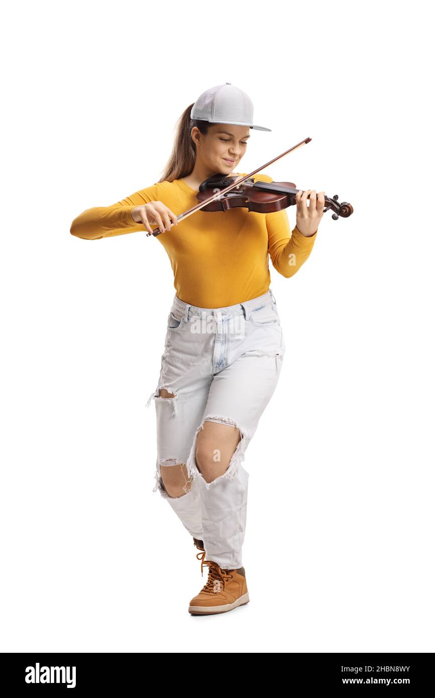 Young female violinist in jeans and yellow top playing a violin ...