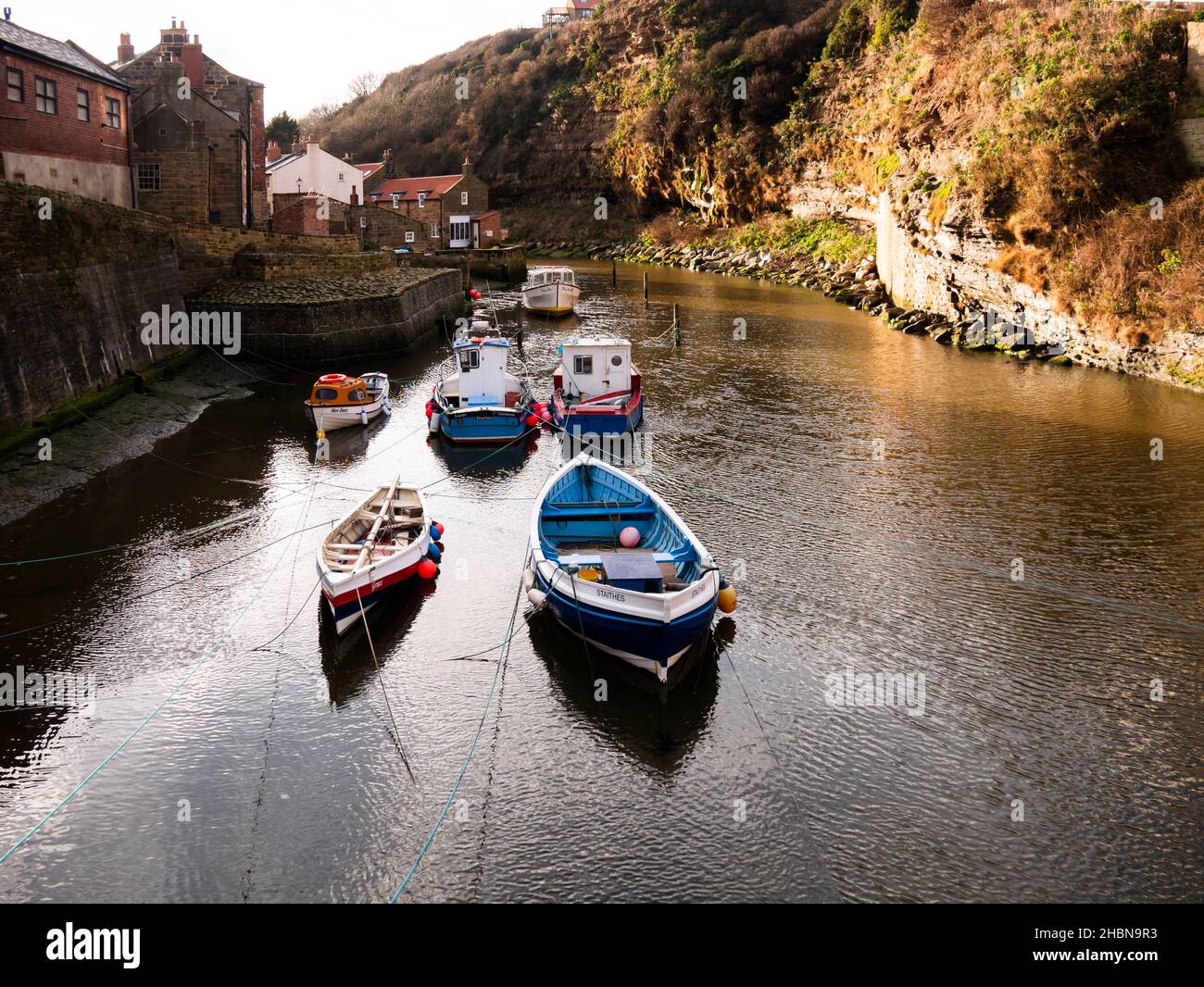 The view looking up Roxby Beck from Cowbar with Staithes fishing boats ...