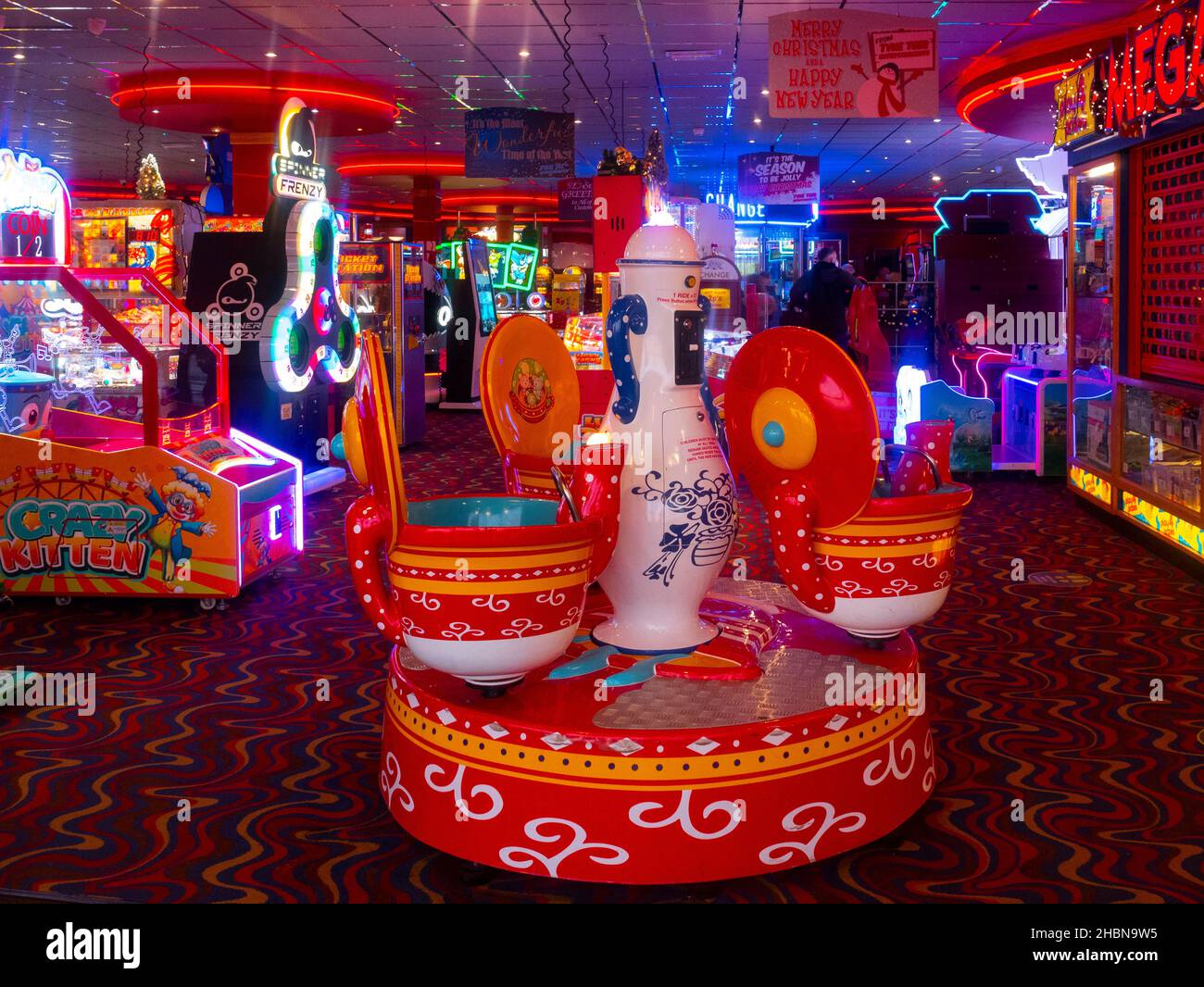 An almost empty Amusement Arcade on the sea front on a winter evening ...