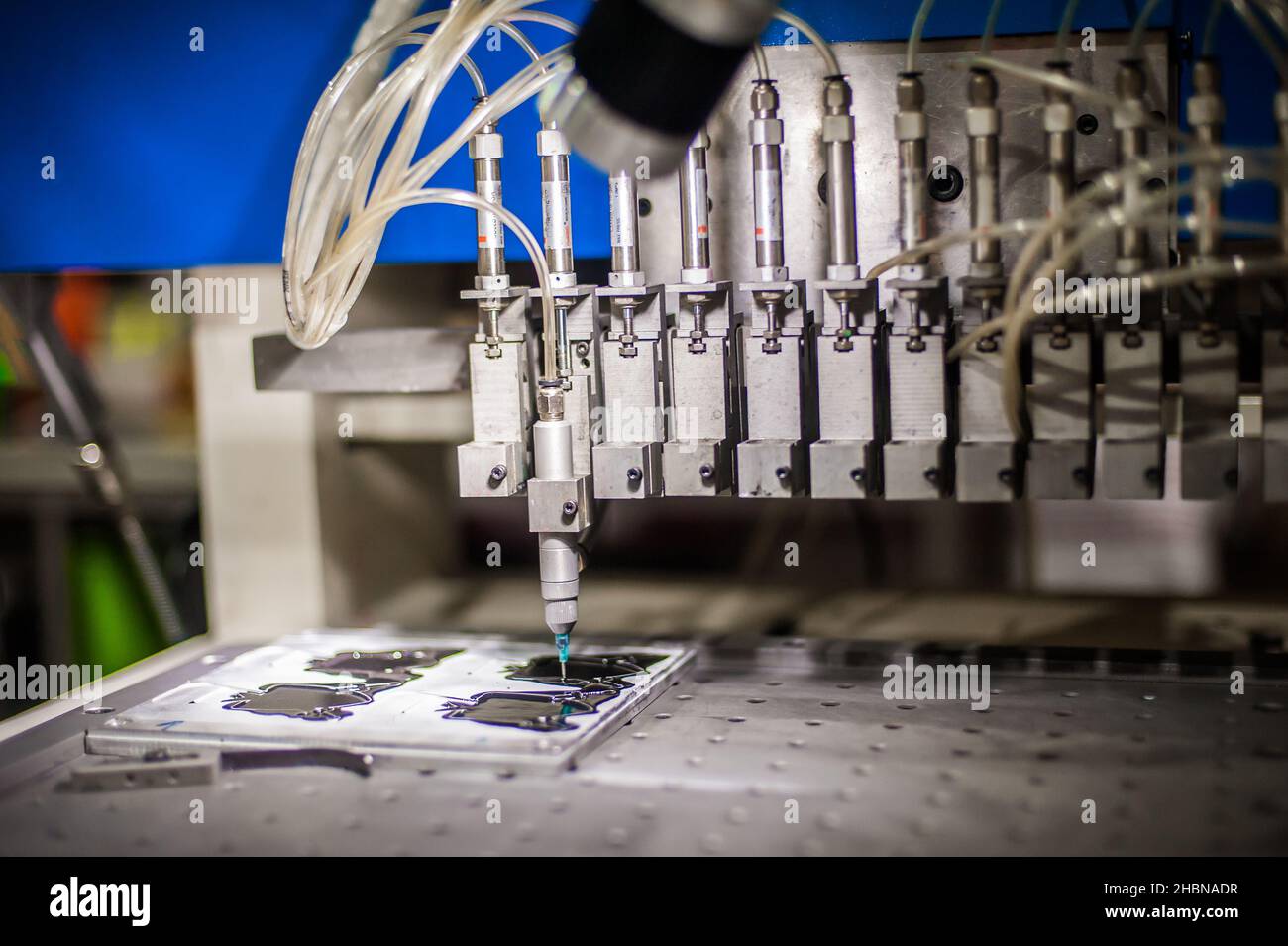 Closeup detail view of soft PVC dispensing machine head in factory ...