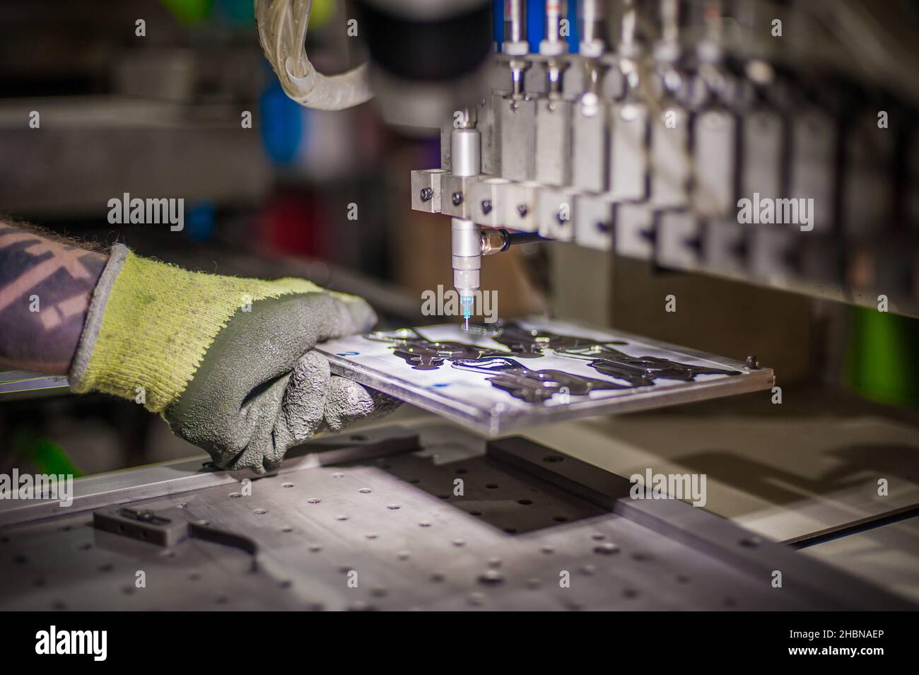 Closeup detail view of soft PVC dispensing machine head in factory ...