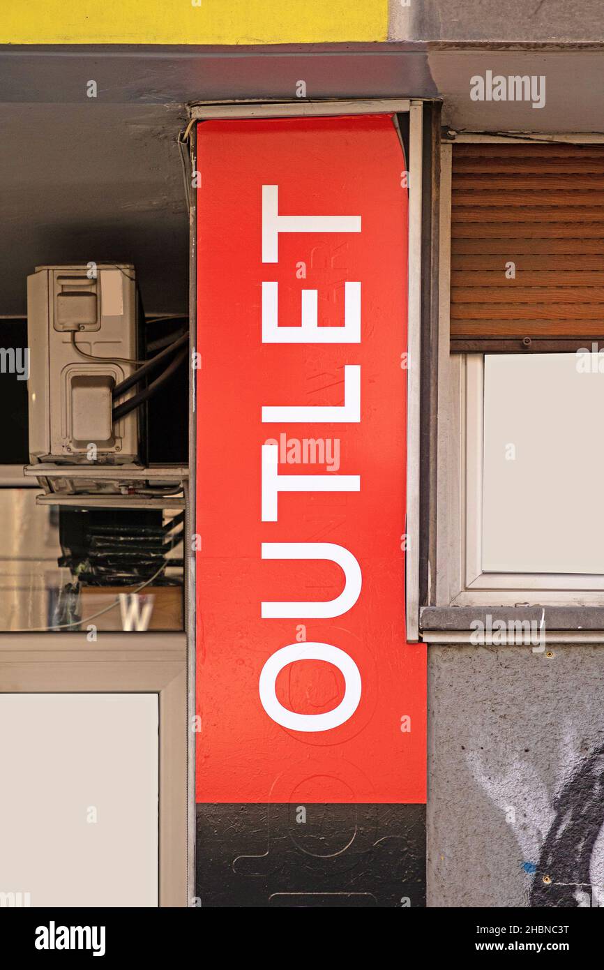 Large banner OUTLET sign on building facade outdoors Stock Photo - Alamy