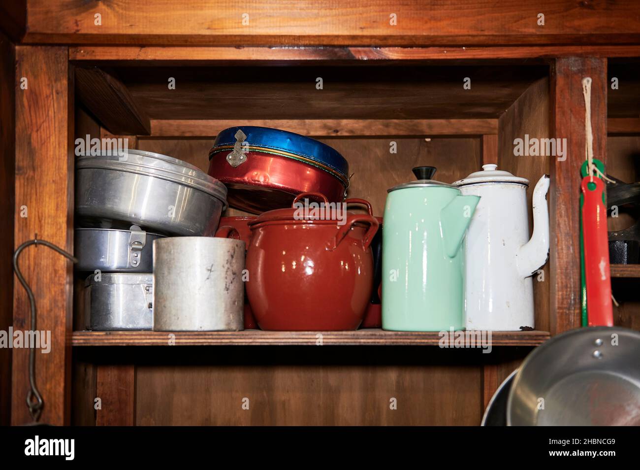old kitchen utensils in wooden cupboard Stock Photo - Alamy