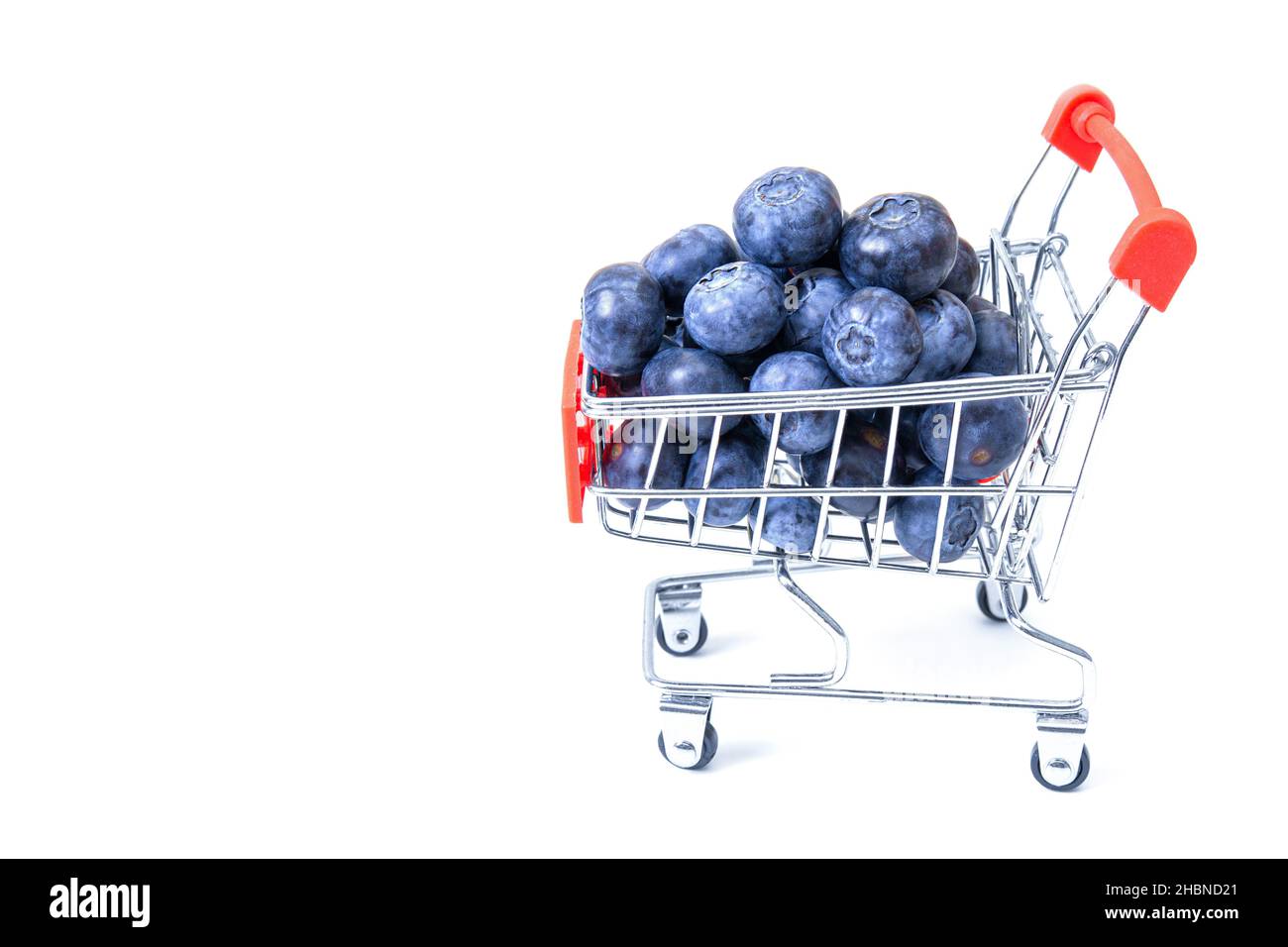 Small push cart full of fresh blueberries isolated on white background ...