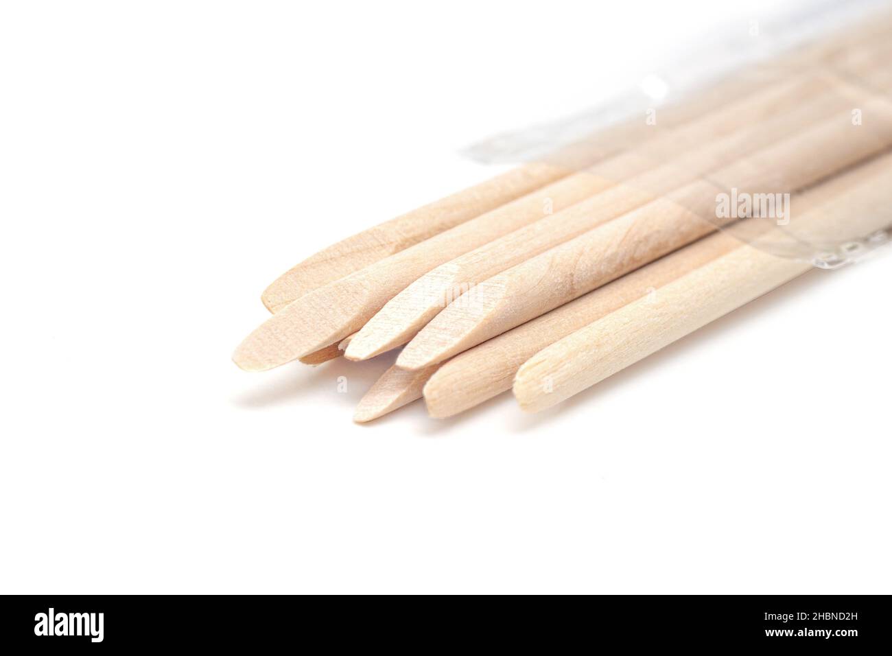 Pile of orange cuticle sticks isolated on white Stock Photo - Alamy